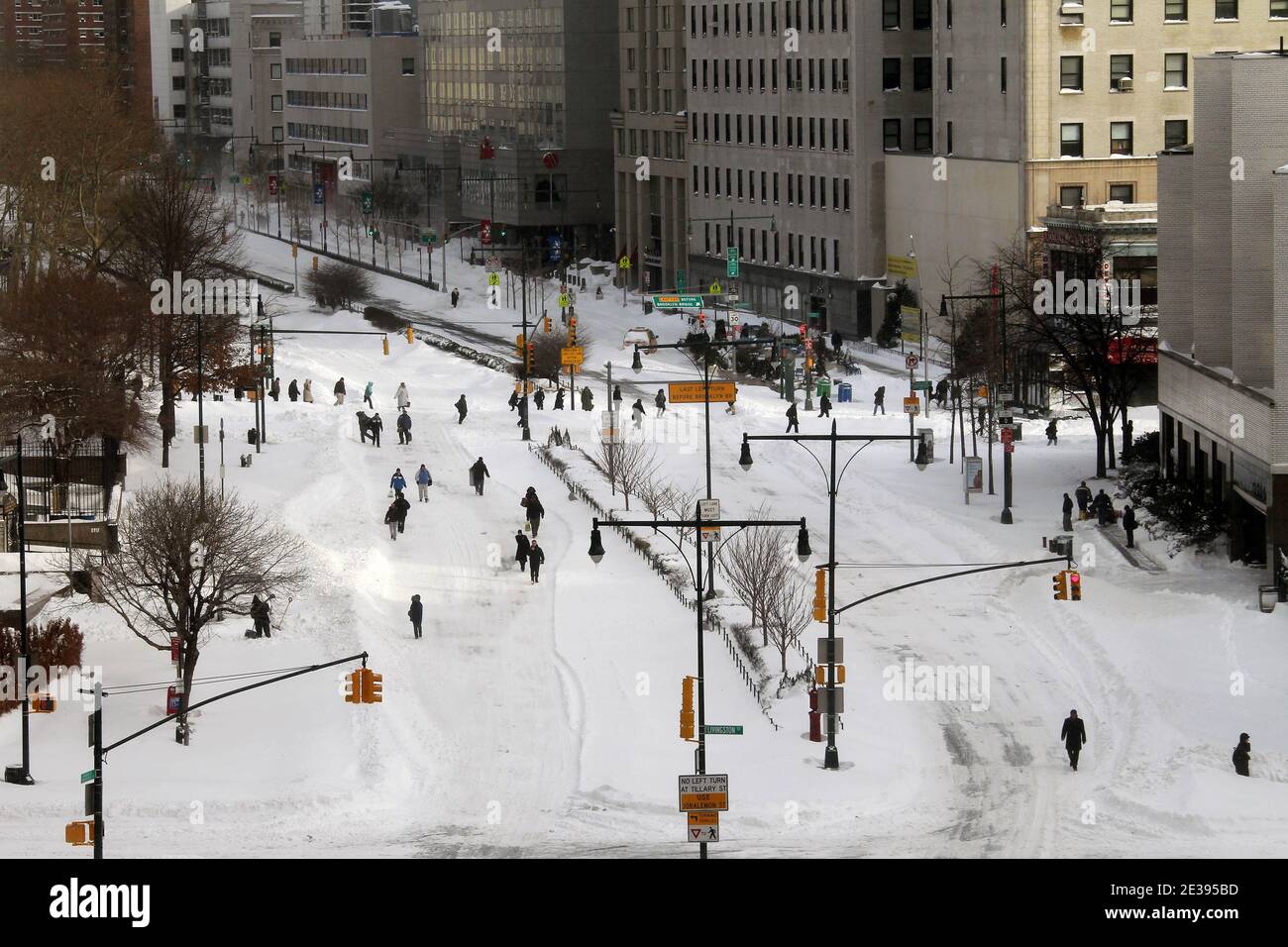 People navigate through the snow-covered street in Downtown Brooklyn in ...