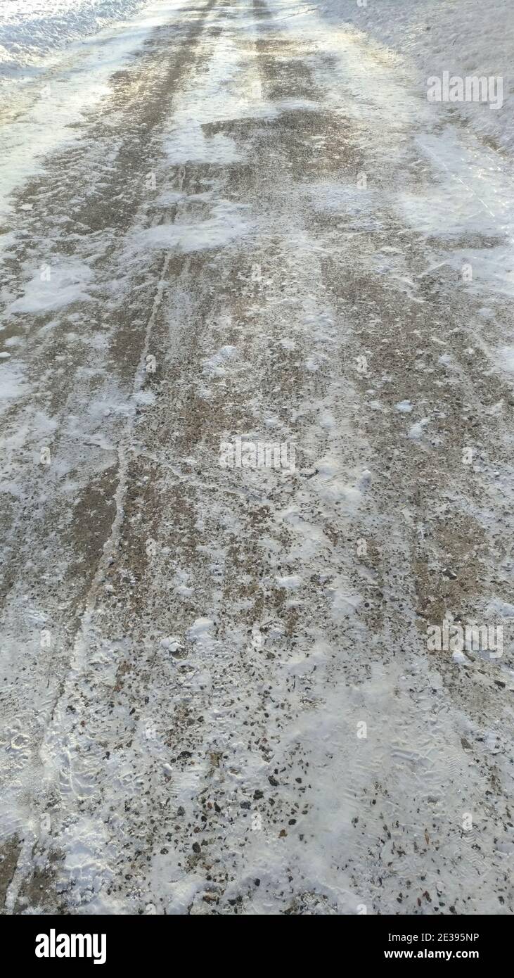 Asphalt road, track partially cleared of snow Stock Photo - Alamy