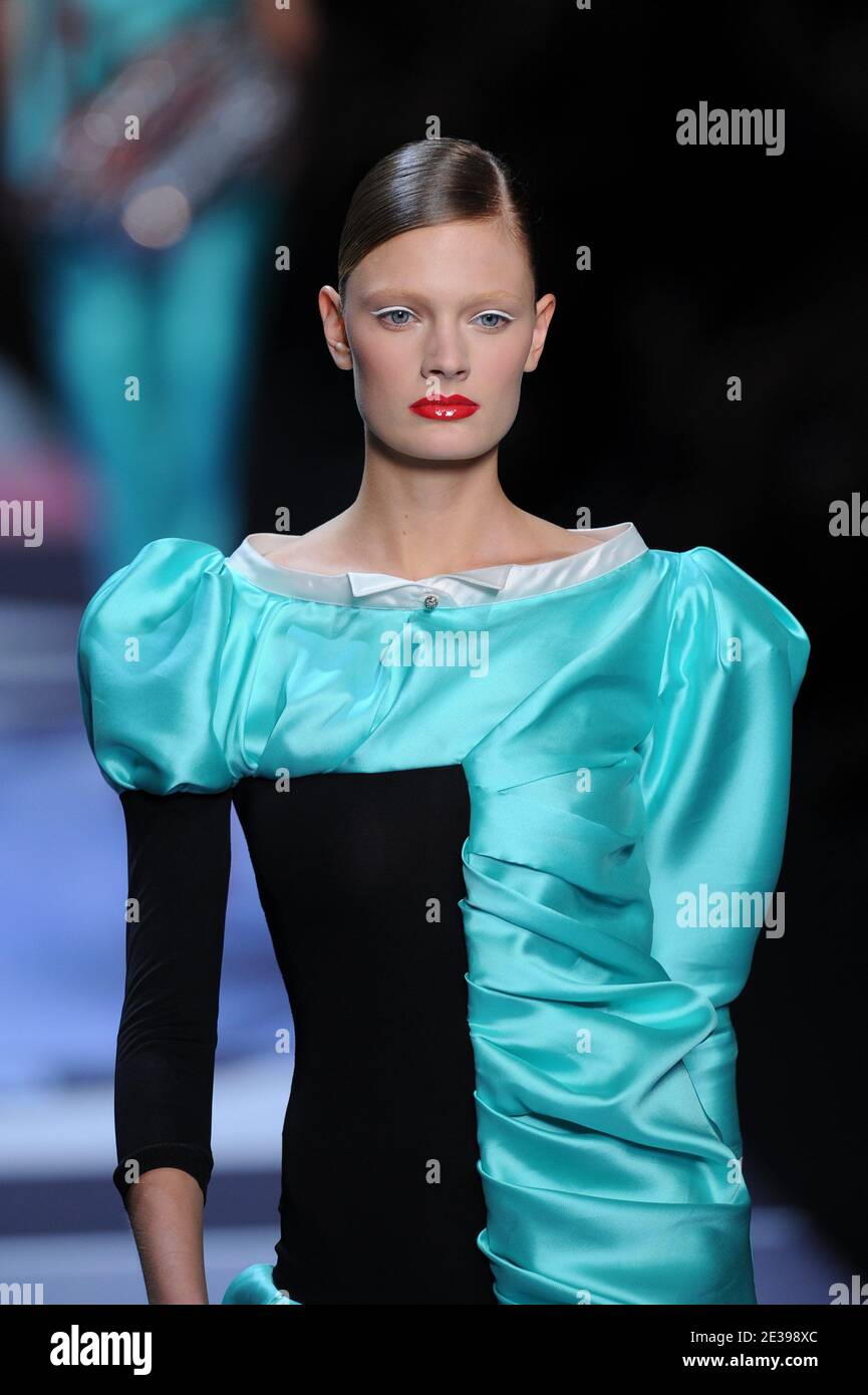 Constance Jablonski displays a creation by designer Viktor and Rolf ...