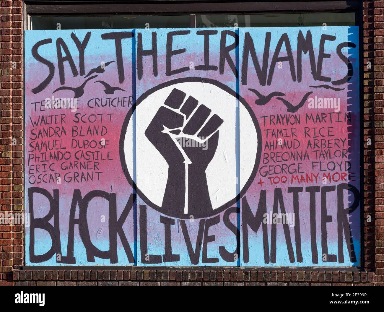 Black Lives Matter mural on a boarded up business with a fist and the ...