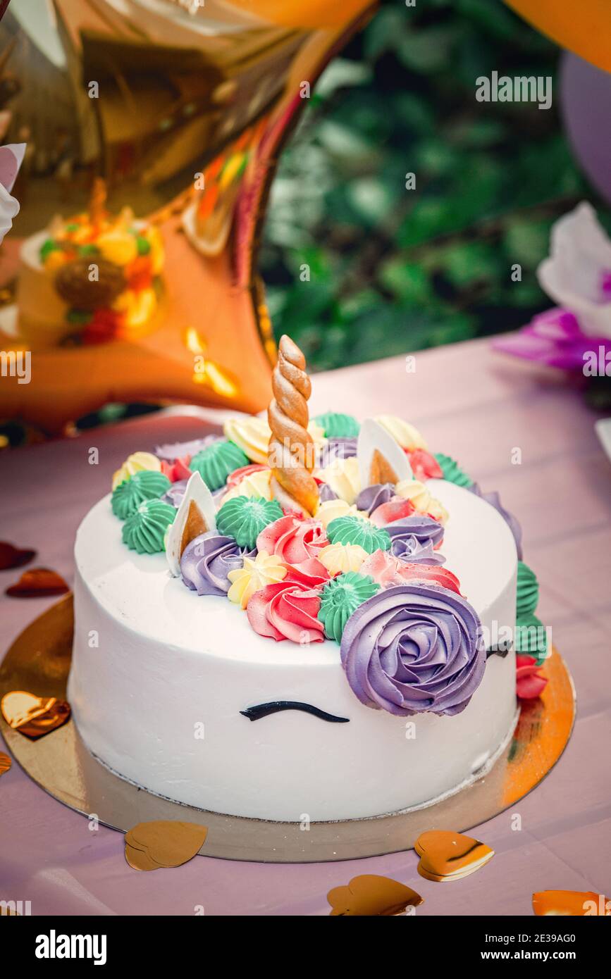 Colorful Birthday cake with sweet icing and a candle Stock Photo - Alamy