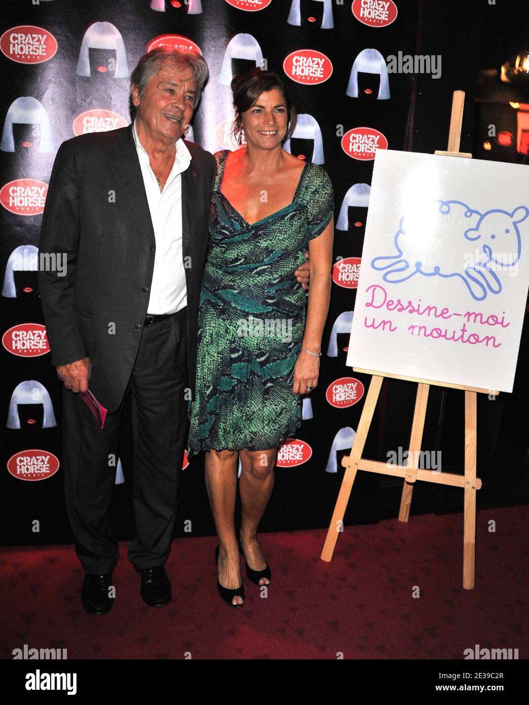Alain Delon poses with Catherine Bertrand (director of the association) during a special night ...