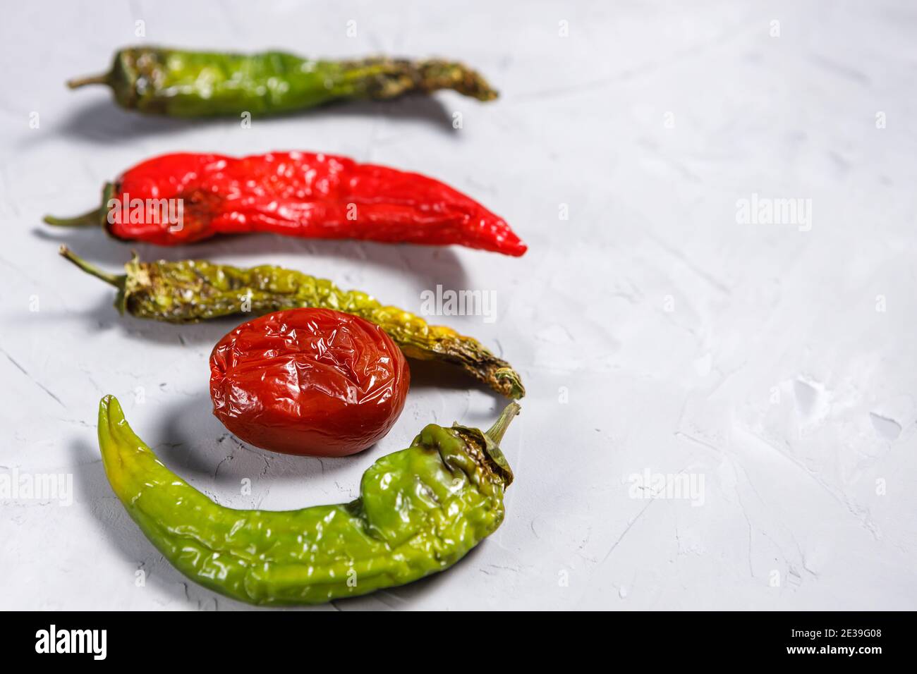Chili peppers and tomatoes are spoiled, shriveled and rotten. Ugly food ...