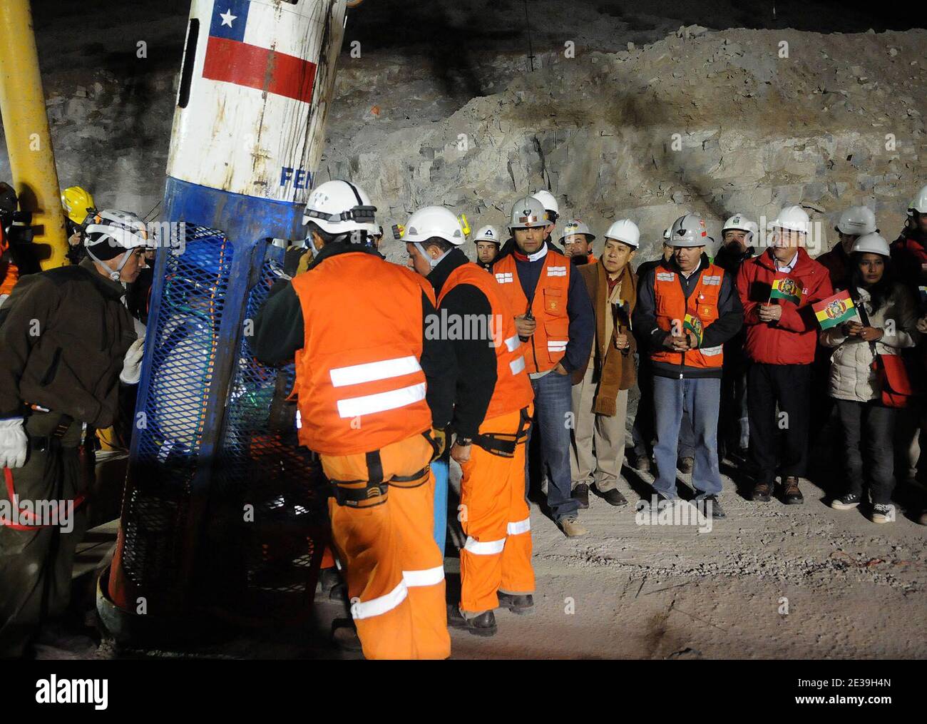 The capsule with Bolivian miner, Carlos Mamani, the 4th miner to be rescued, arrives after his ...