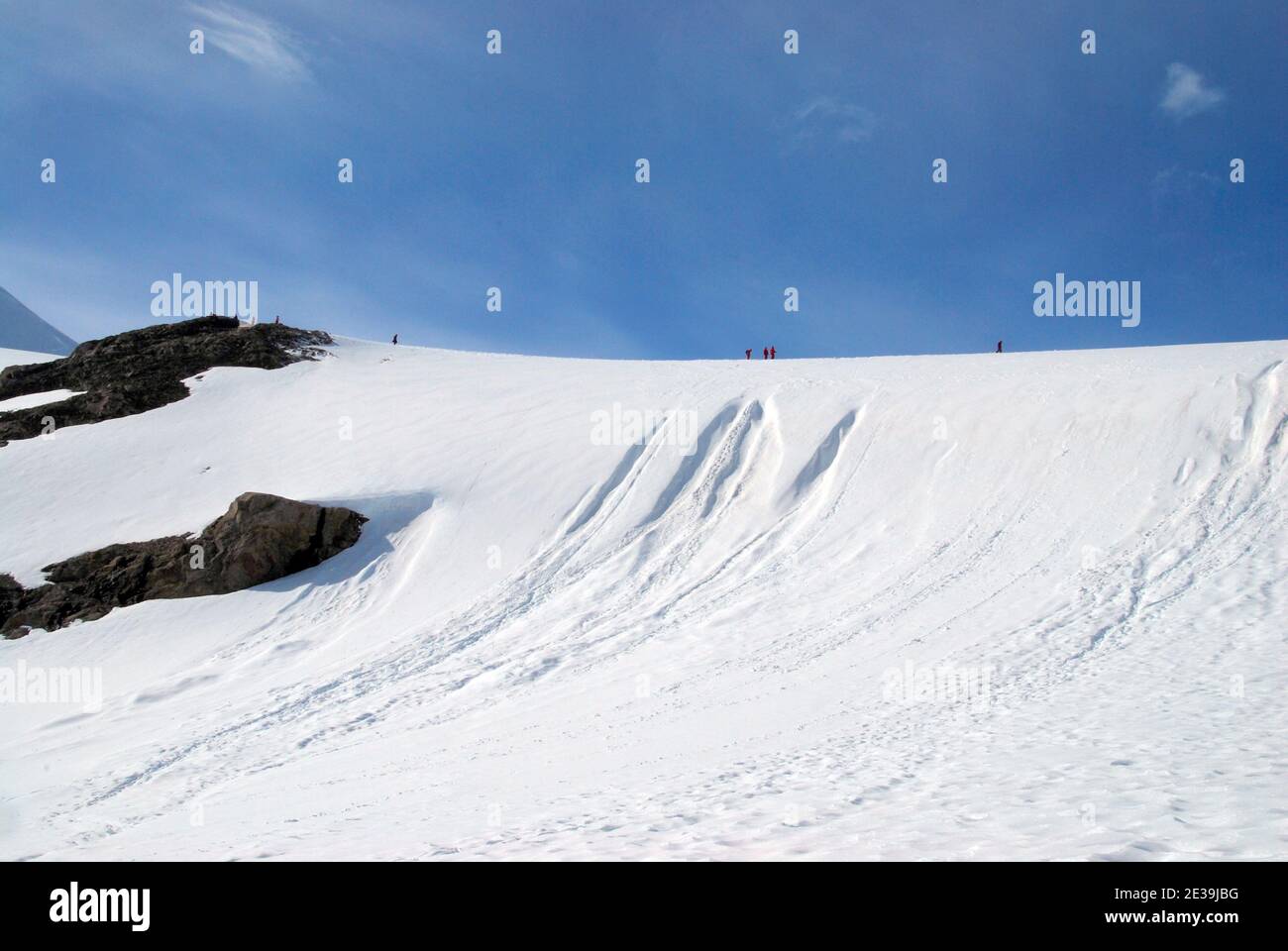 Tourists from an Antarctic Cruise Expedition ship climb a snowy ...