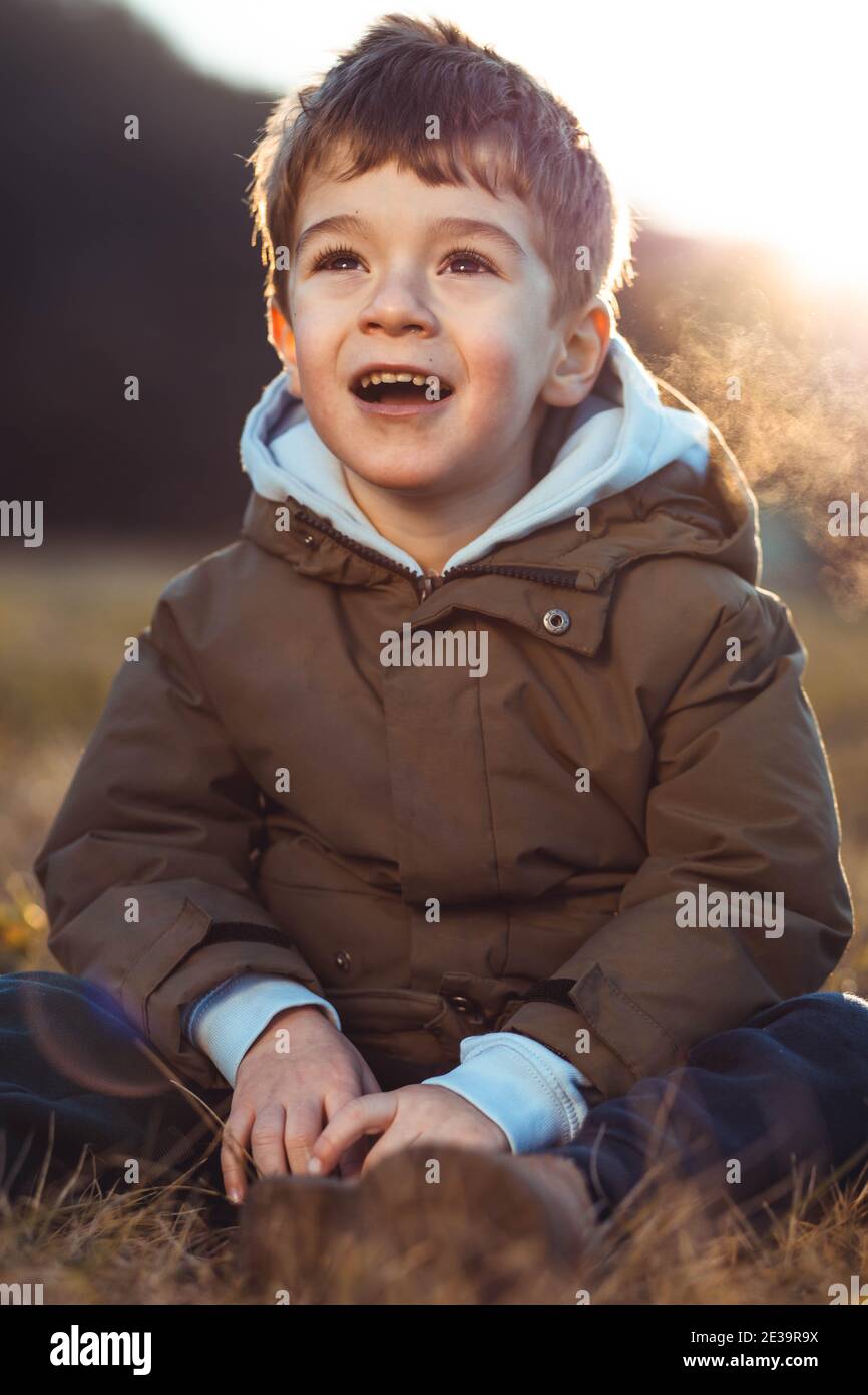 Portrait of a cute, little boy looking at something in awe, with an ...