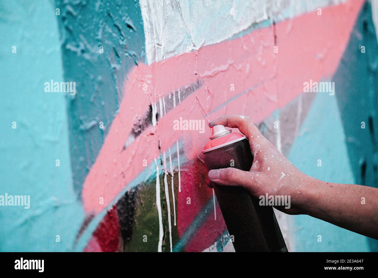 A closeup shot of an artist's hand holding a paint spray can for ...