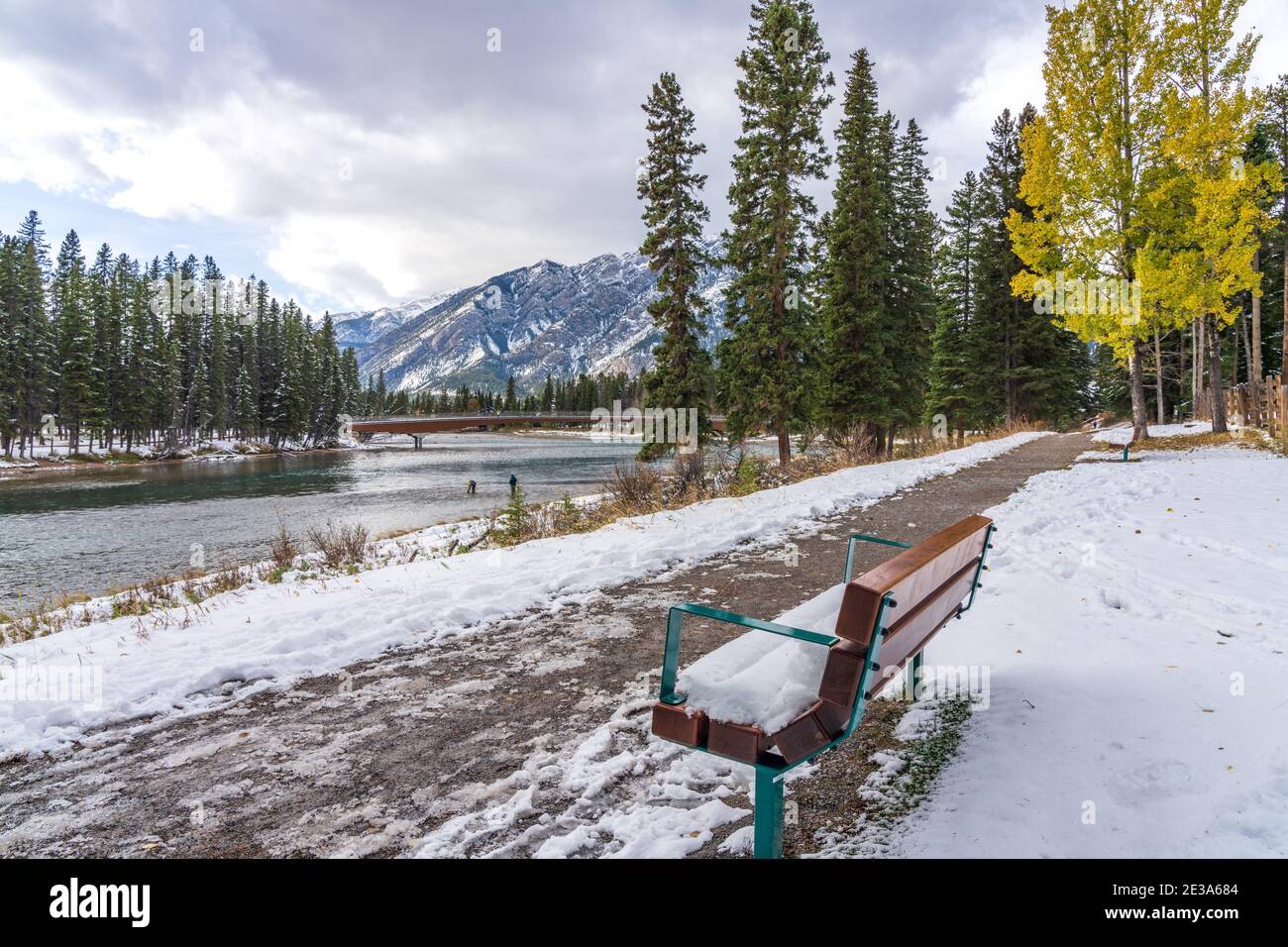 Banff Pedestrian Bridge and Bow River trail in snowy autumn day. Banff ...