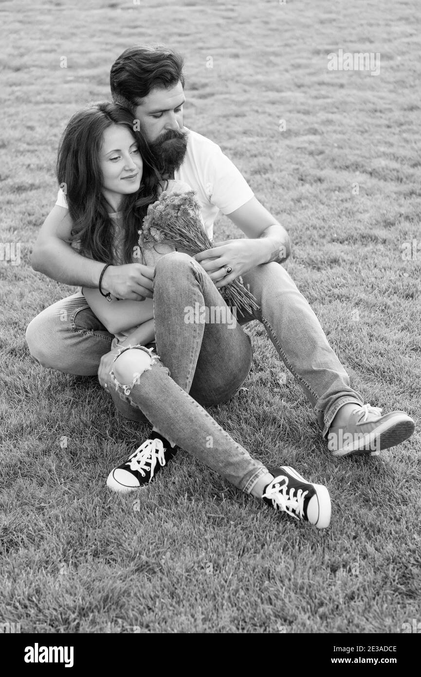 Lovely couple cuddling relaxing on green meadow, womens day concept ...