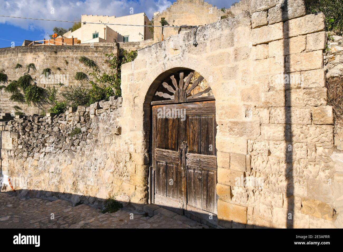 A vintage, weathered brown door in the ancient sassi city of Matera ...
