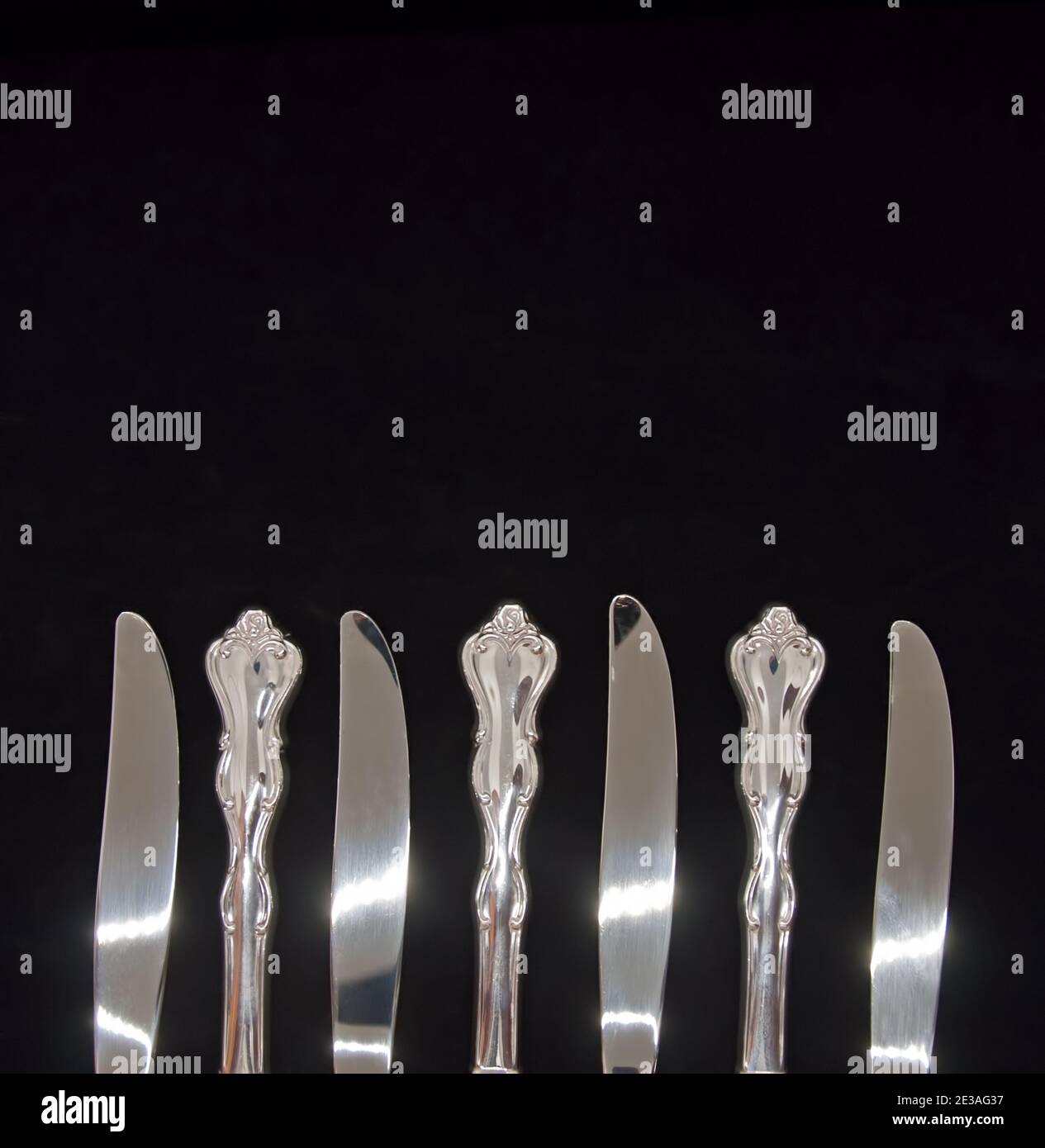 A photographic bottom border of seven sterling silver knives showing ...