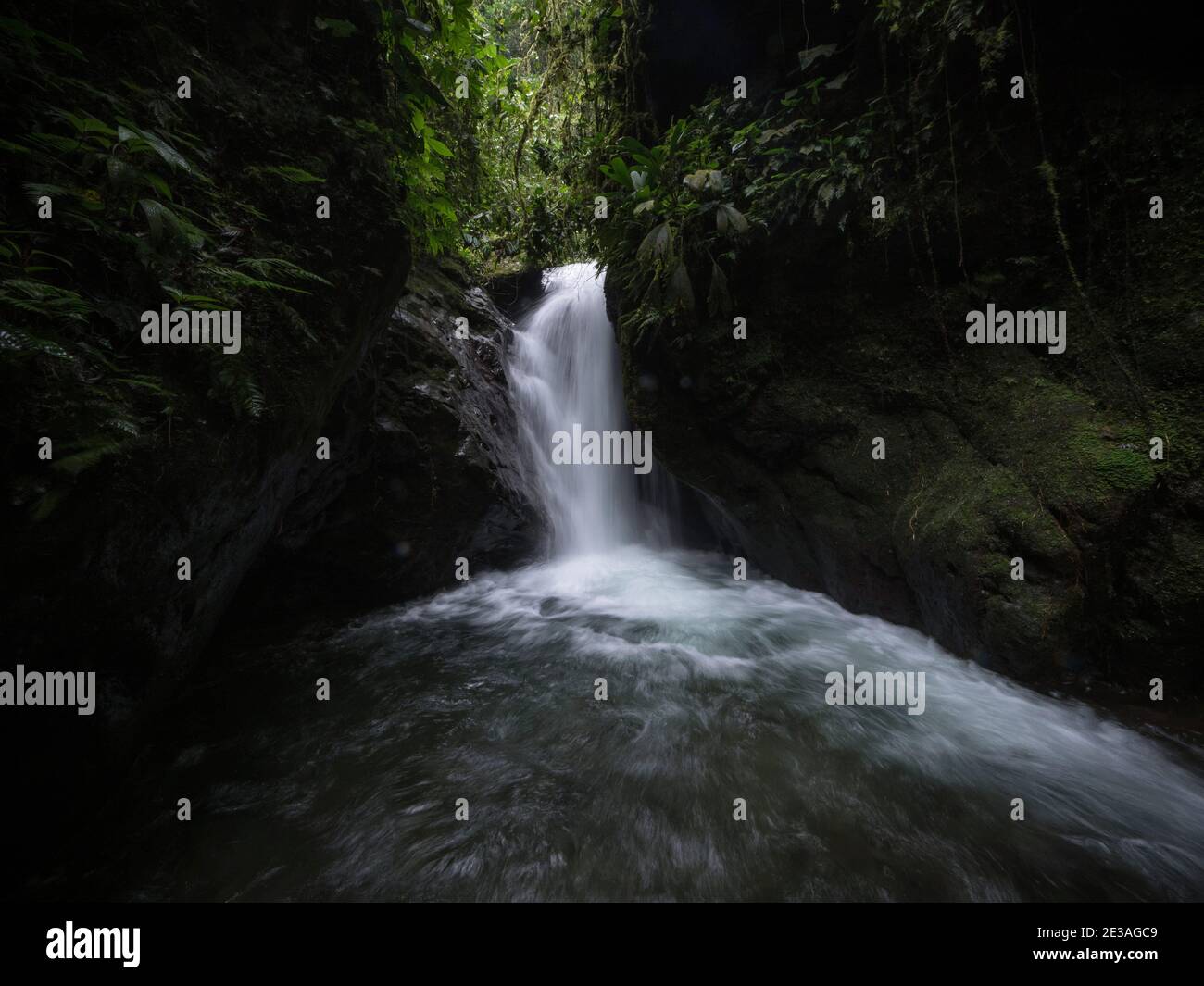Panorama view of Cascada Colibries waterfall in tropical rain cloud ...