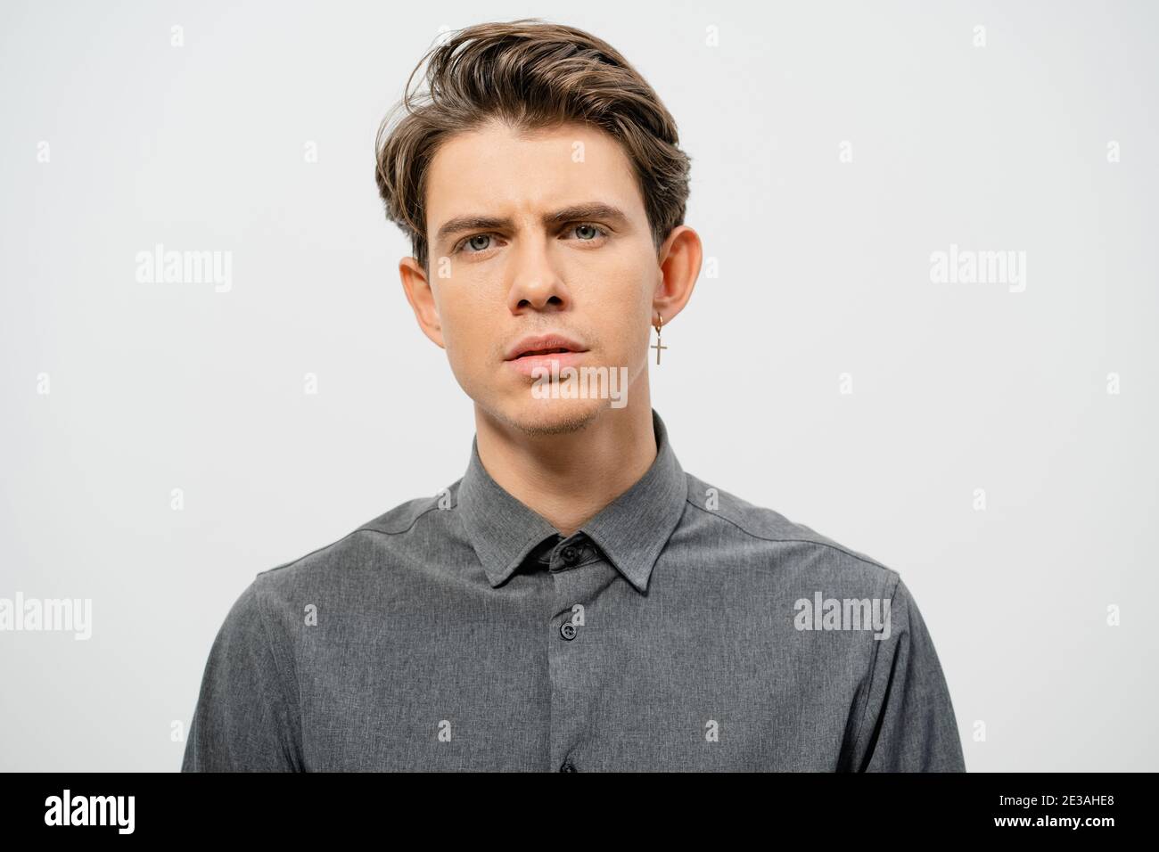 Young handsome man with a questioning face studio portrait. Boy style ...