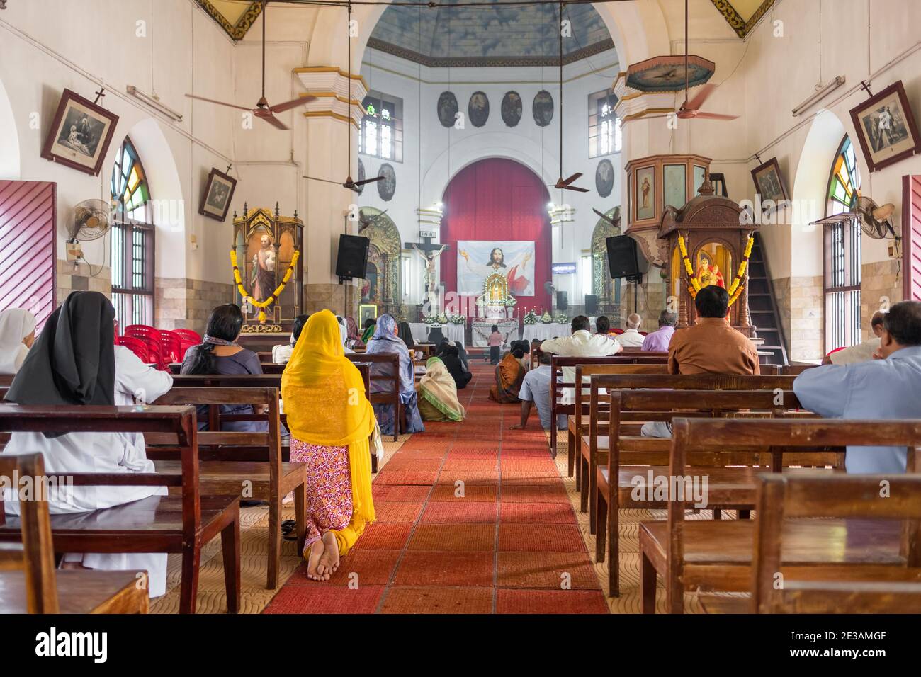 Unidentified indian people praying during holy mass in christian church ...