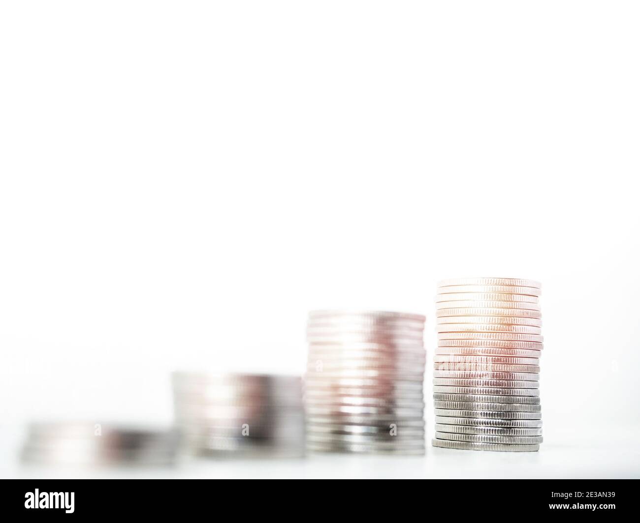 Coin stacks isolated on a white background with copy space, focus on ...