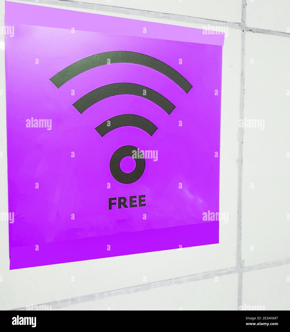 Free Wi-Fi zone symbol, purple sign on a white wall in a public empty ...
