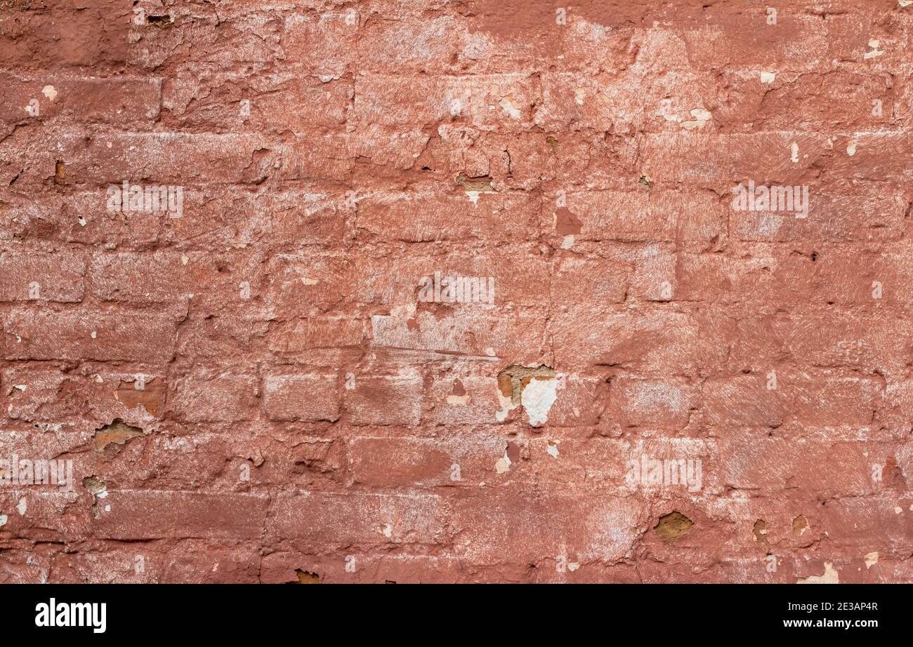 Full frame abstract background of an antique rose color painted brick ...