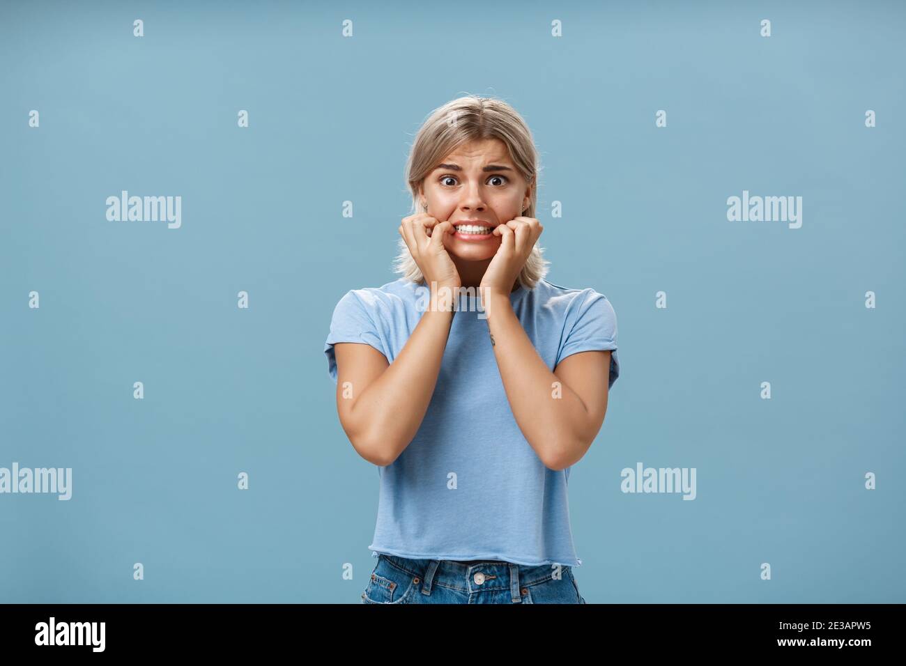 Gosh scary movies makes me tremble. Portrait of worried young ...