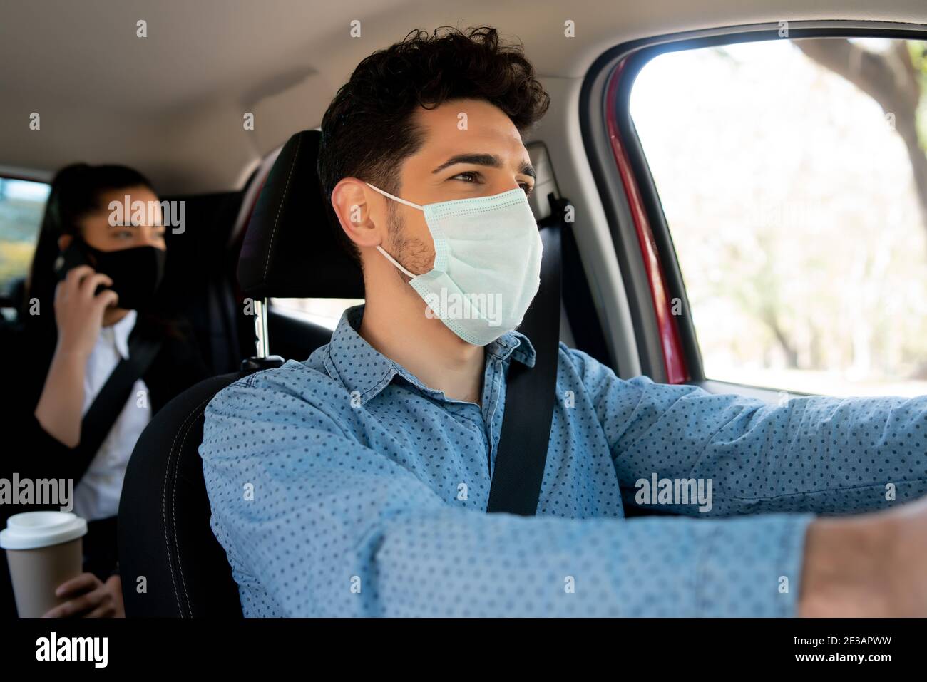 Taxi driver with passenger at back seat Stock Photo - Alamy