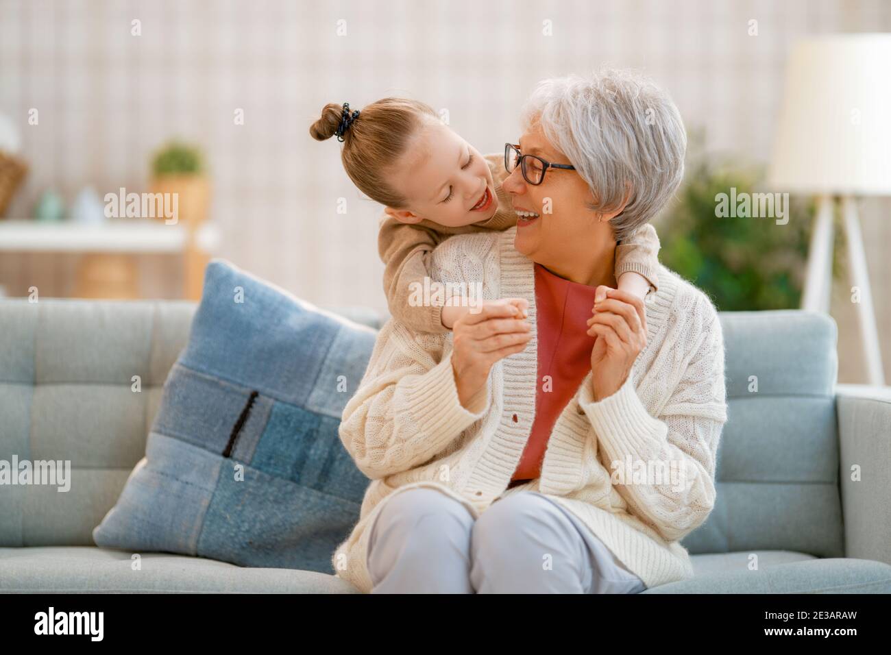 A nice girl and her grandmother enjoying sunny morning. Good time at ...