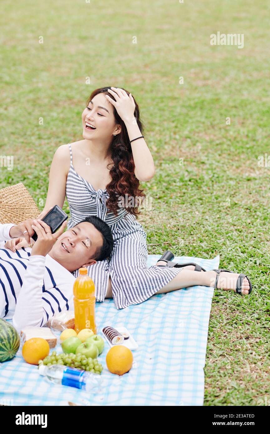 Excited pretty young Asian woman enjoying romantic date with her ...