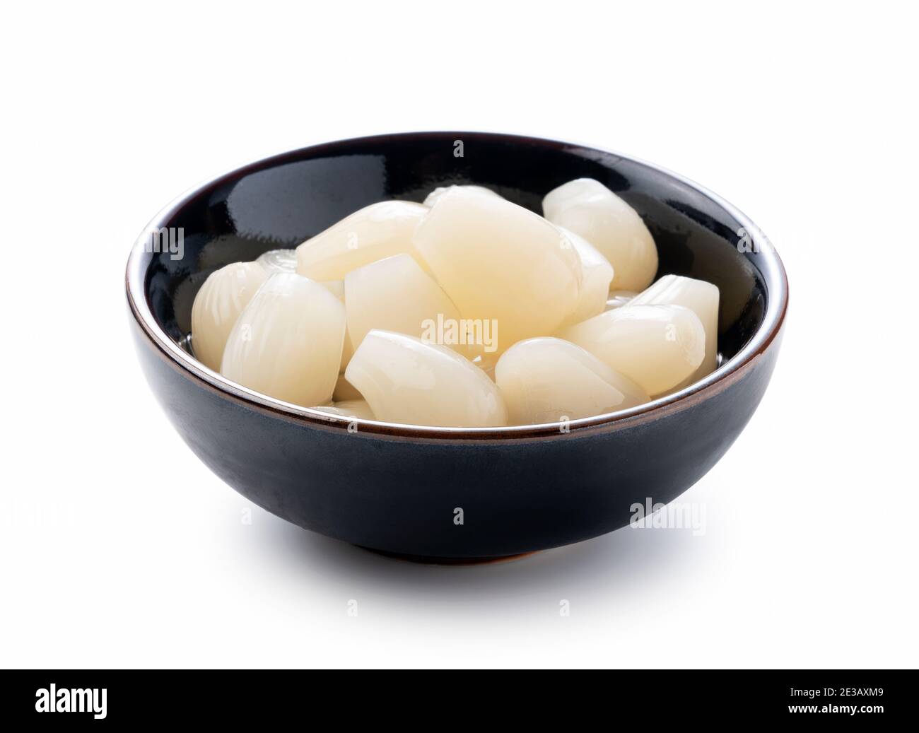 Japanese Rakkyo in a black bowl placed on a white background Stock ...