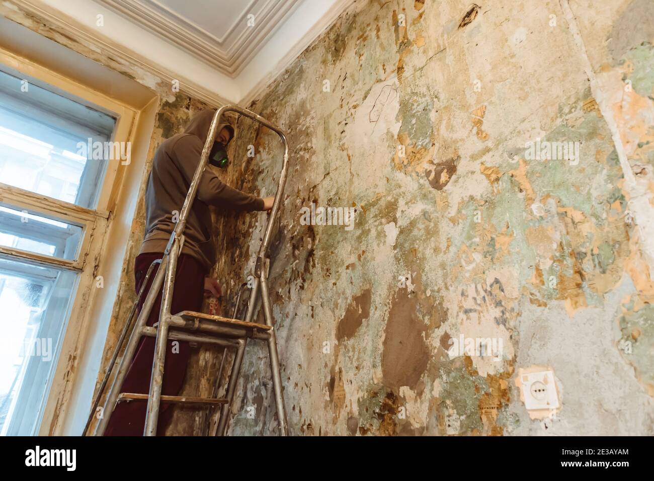 cleaning grinding the walls from home wallpaper worker painter mask ...