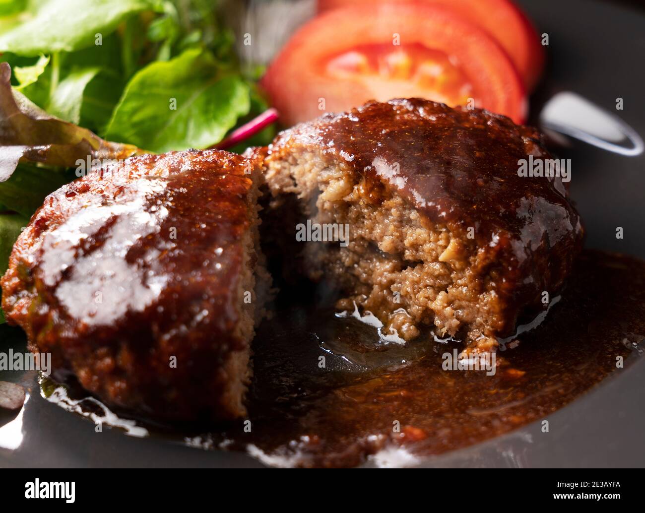 Cross section of hamburger with demi-glace sauce cut in half Stock ...