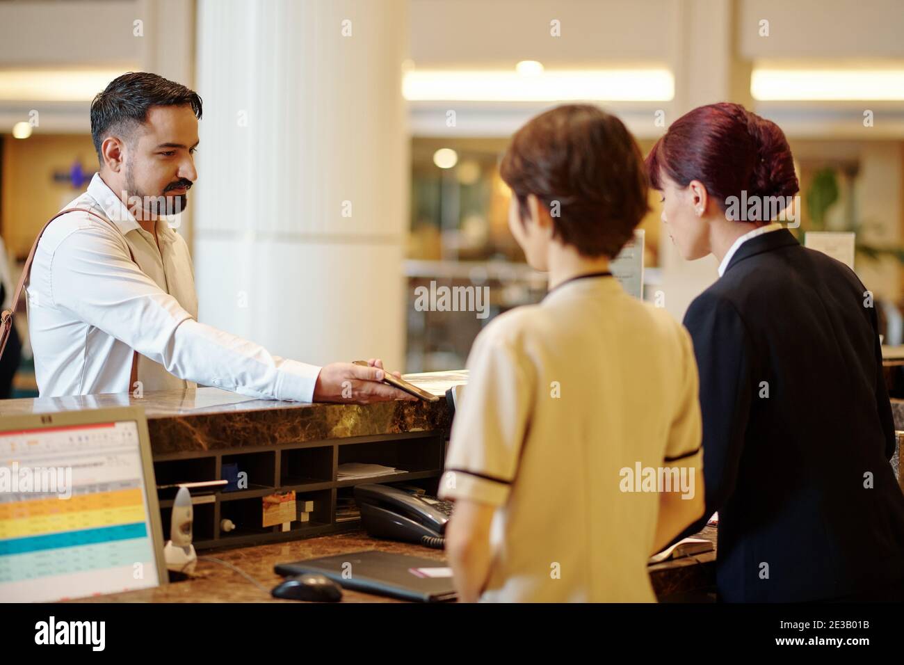 Woman receptionist showing information on hi-res stock photography and ...