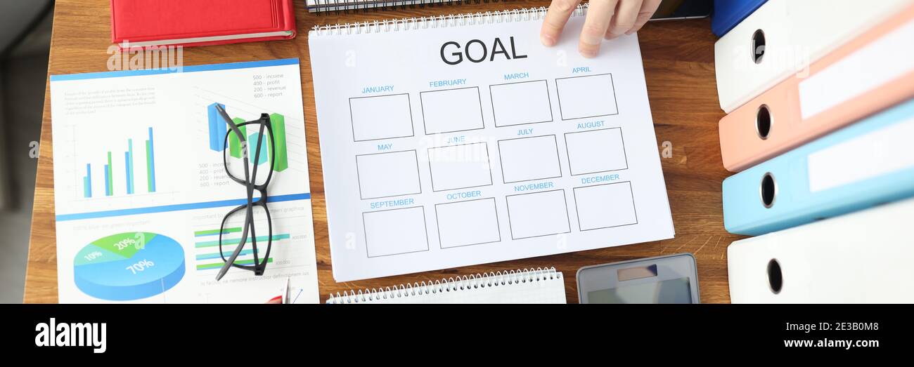 On the desktop is graph with goals for business Stock Photo - Alamy