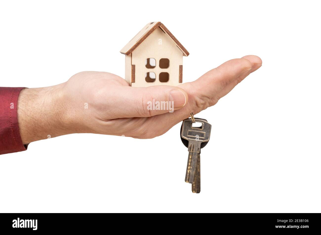 hand holding model house and keys. Close-up of hand holding keys and ...
