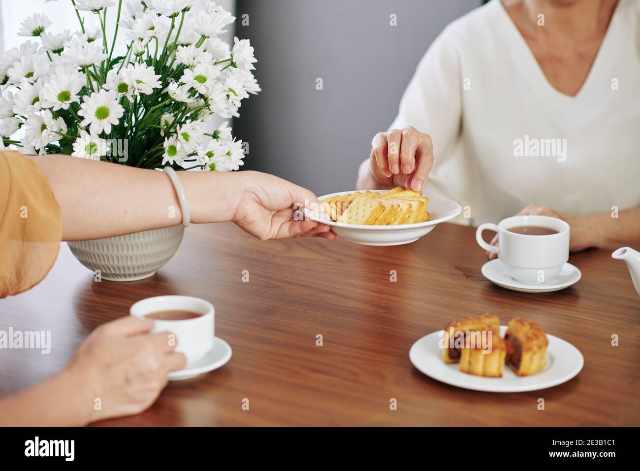 Senior woman offering plate hi-res stock photography and images - Alamy