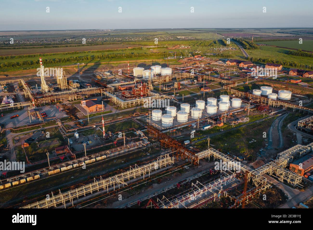 Aerial view oil and gas refinery. Pipes and large tanks and scaffold ...