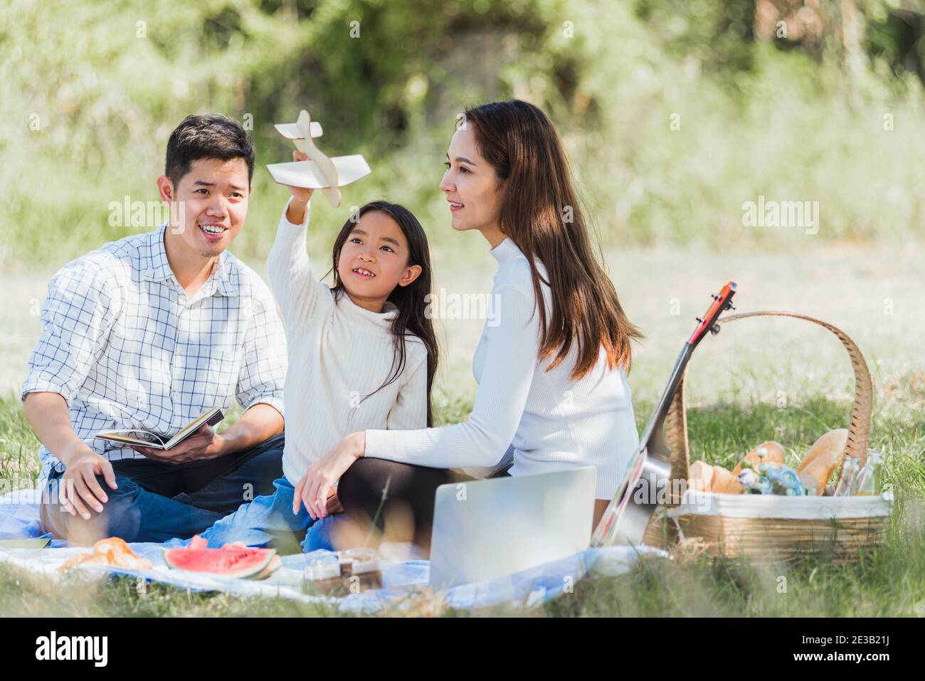 Happy Asian young family father, mother and child little girl having ...