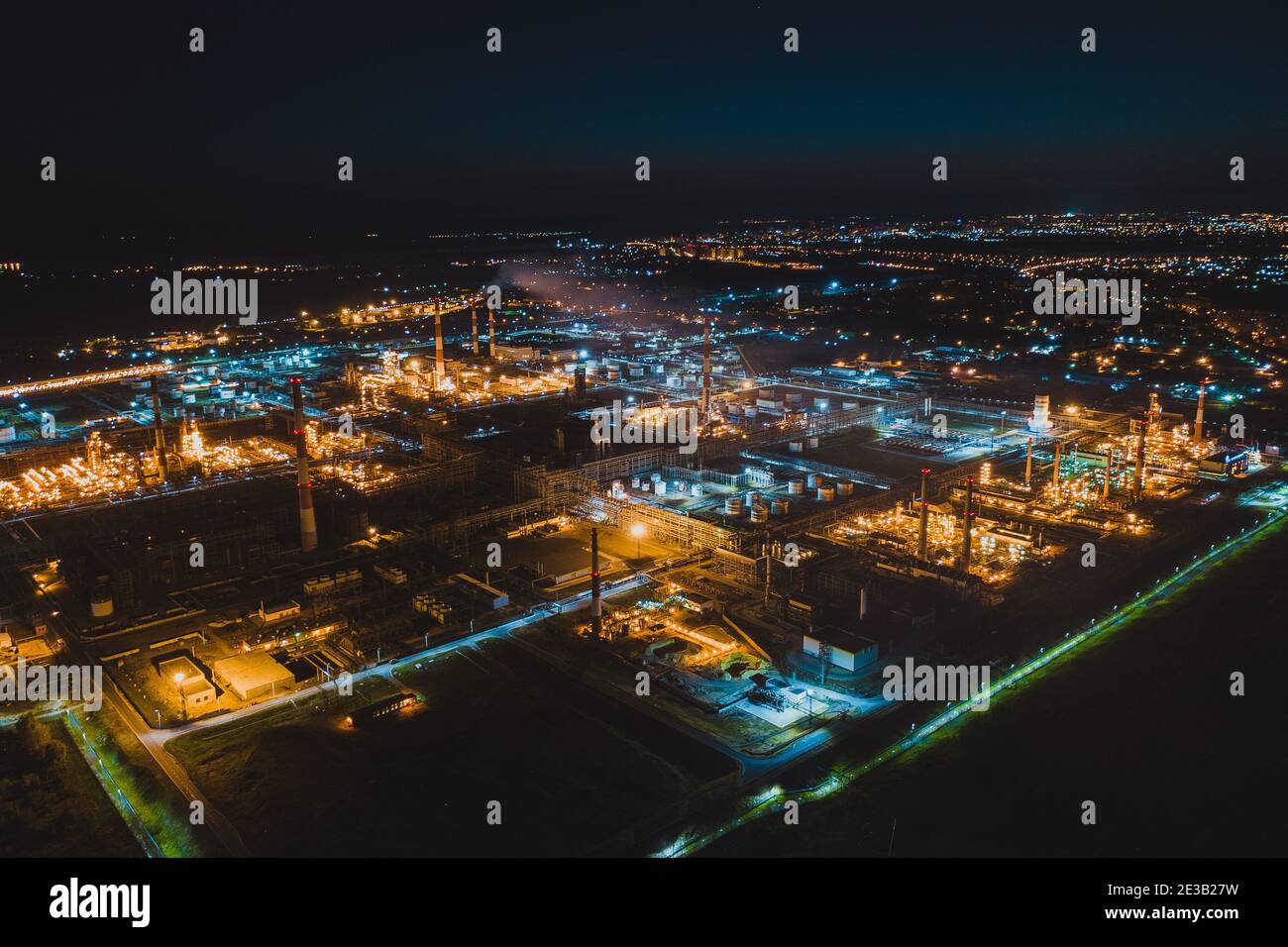 Oil and gas oil refinery at night. Pipes and large tanks with night ...