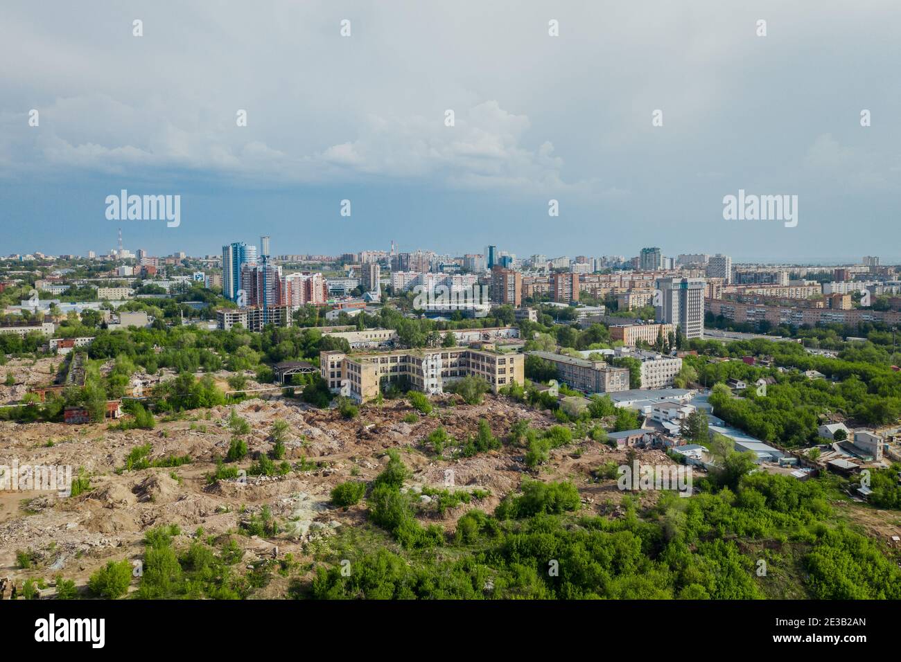 Ruins of old factory in center of modern city, overgrown by trees Stock ...