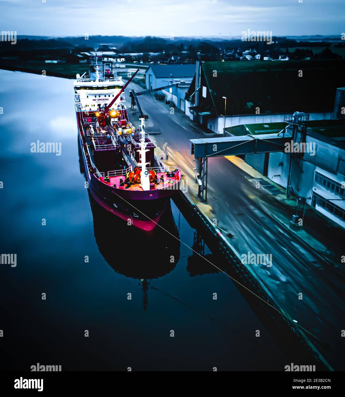 Tanker ship moored at port while unloading oil Stock Photo - Alamy