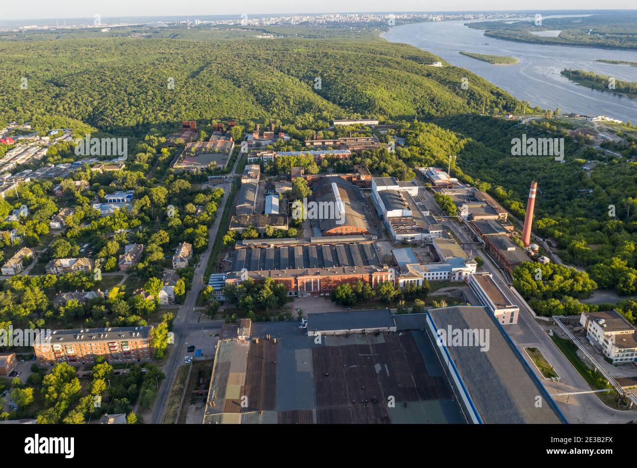 Old USSR factory in center of modern city, overgrown by trees Stock ...