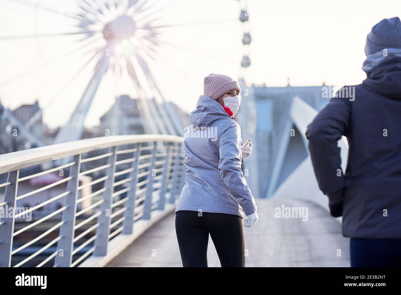 Adult couple jogging in the city in masks during lockdown Stock Photo ...