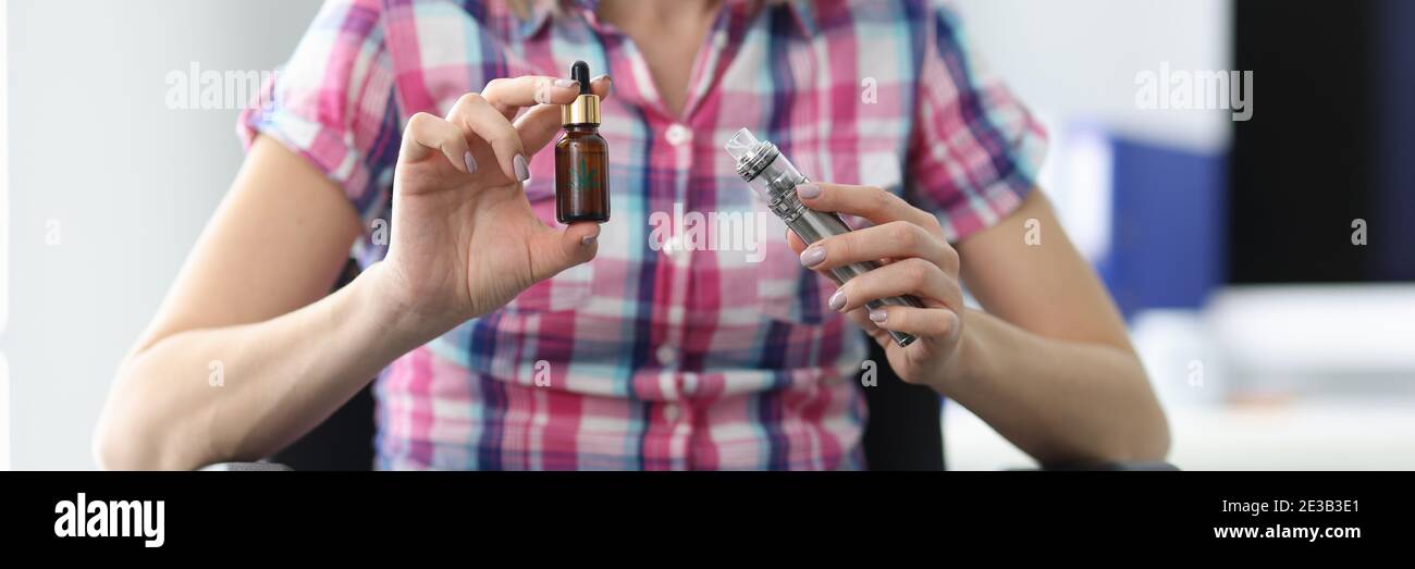 Woman in wheelchair is holding marijuana and an electronic cigarette ...