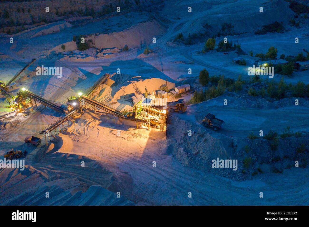 Open cast mine at night with concentrating mill and back-loader Stock ...