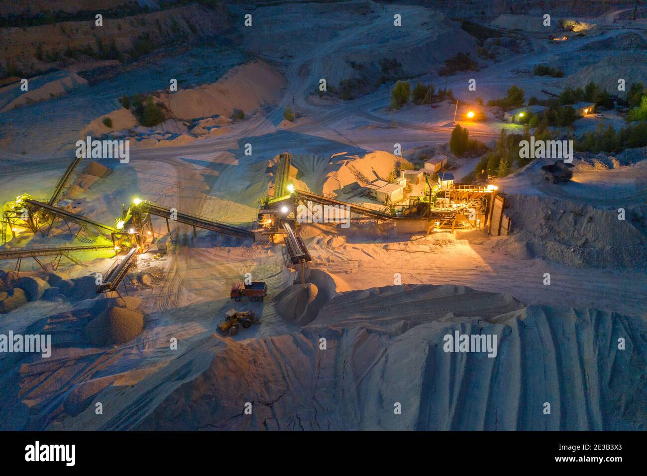 Open cast mine at night with concentrating mill and back-loader Stock ...