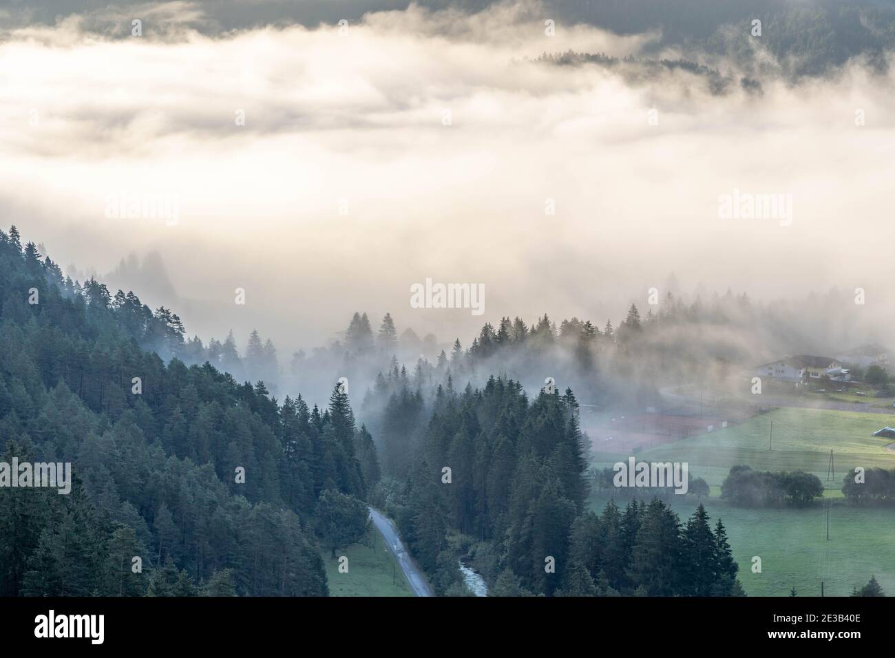 Heavy morning fog mist over road in Gaicht Austria Village in morning ...