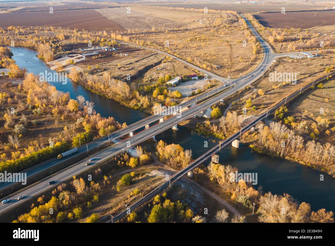 Small river country side bridges with cars moving on road and railroad ...