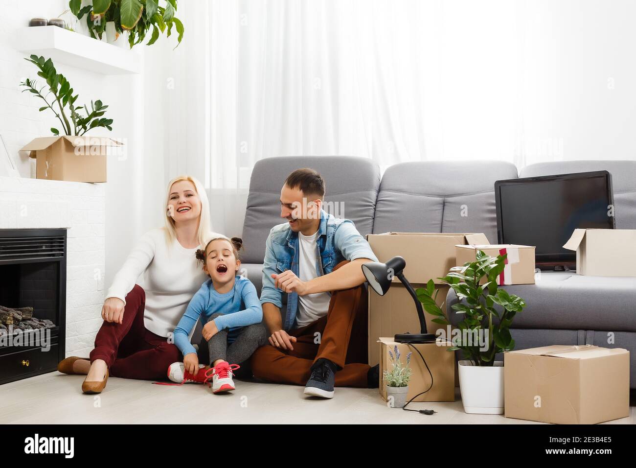 concept housing a young family. Mother father and child in new house ...