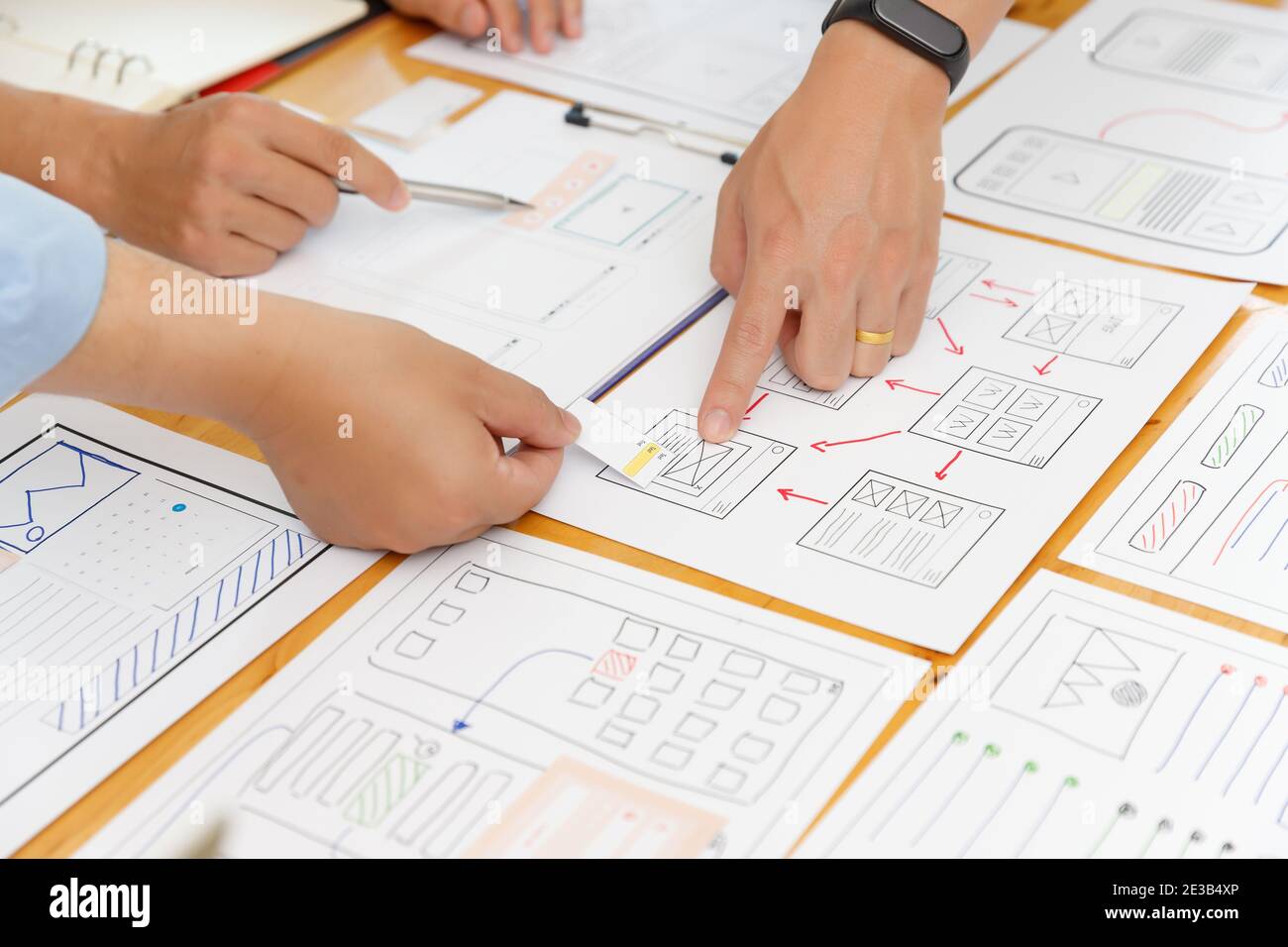 Graphic designers work together with UX UI designer planning ...