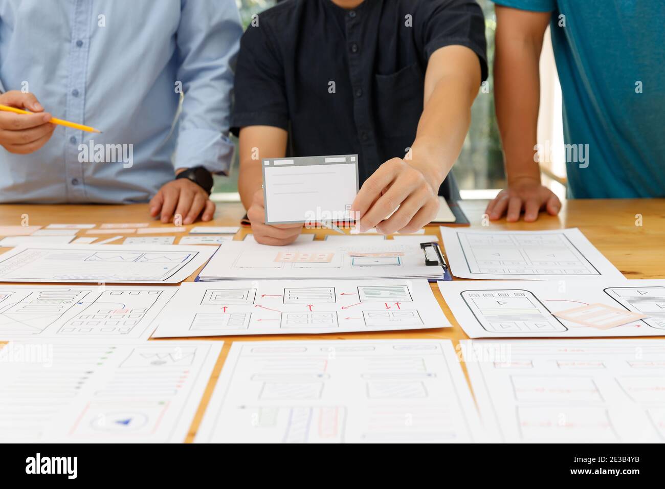 Graphic designers work together with UX UI designer planning ...