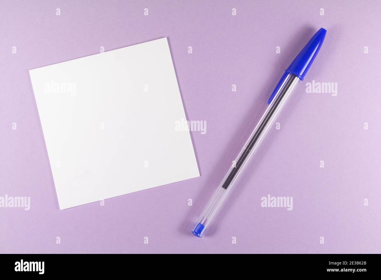 Blue pen and empty paper on purple background Stock Photo - Alamy