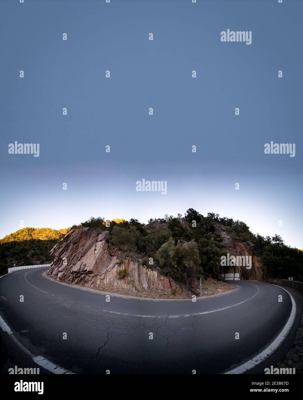 U-shape curved road and tunnel under blue sky Stock Photo - Alamy