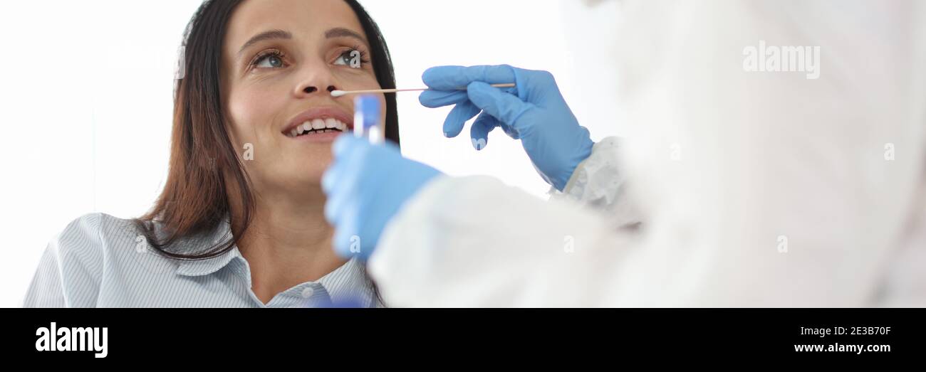 The medical officer takes biological material with cotton swab Stock ...